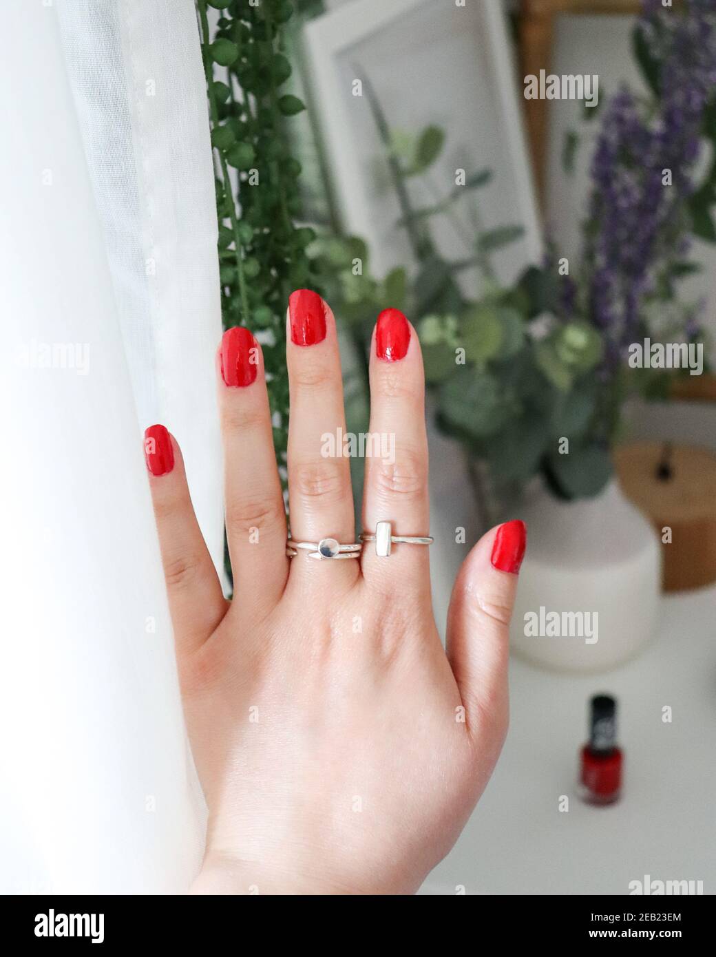 Red painted nails hand wearing rings hi-res stock photography and ...