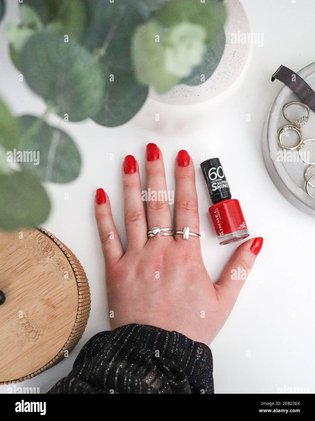 Rimmel nail polish red painted nails beauty hand wearing rings Stock ...