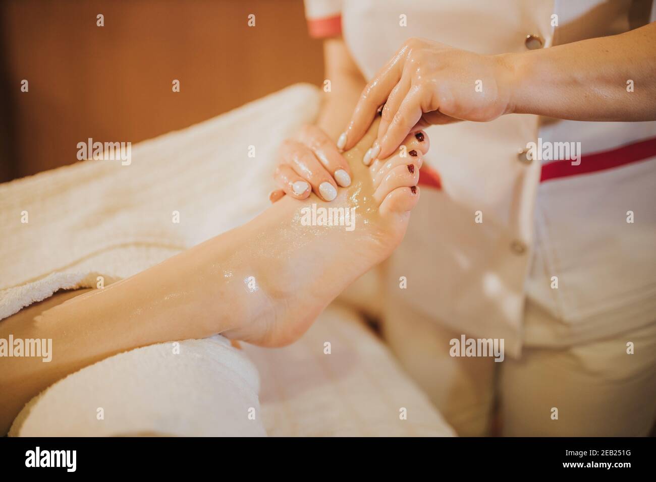 Female getting a professional foot massage in a beauty spa salon ...