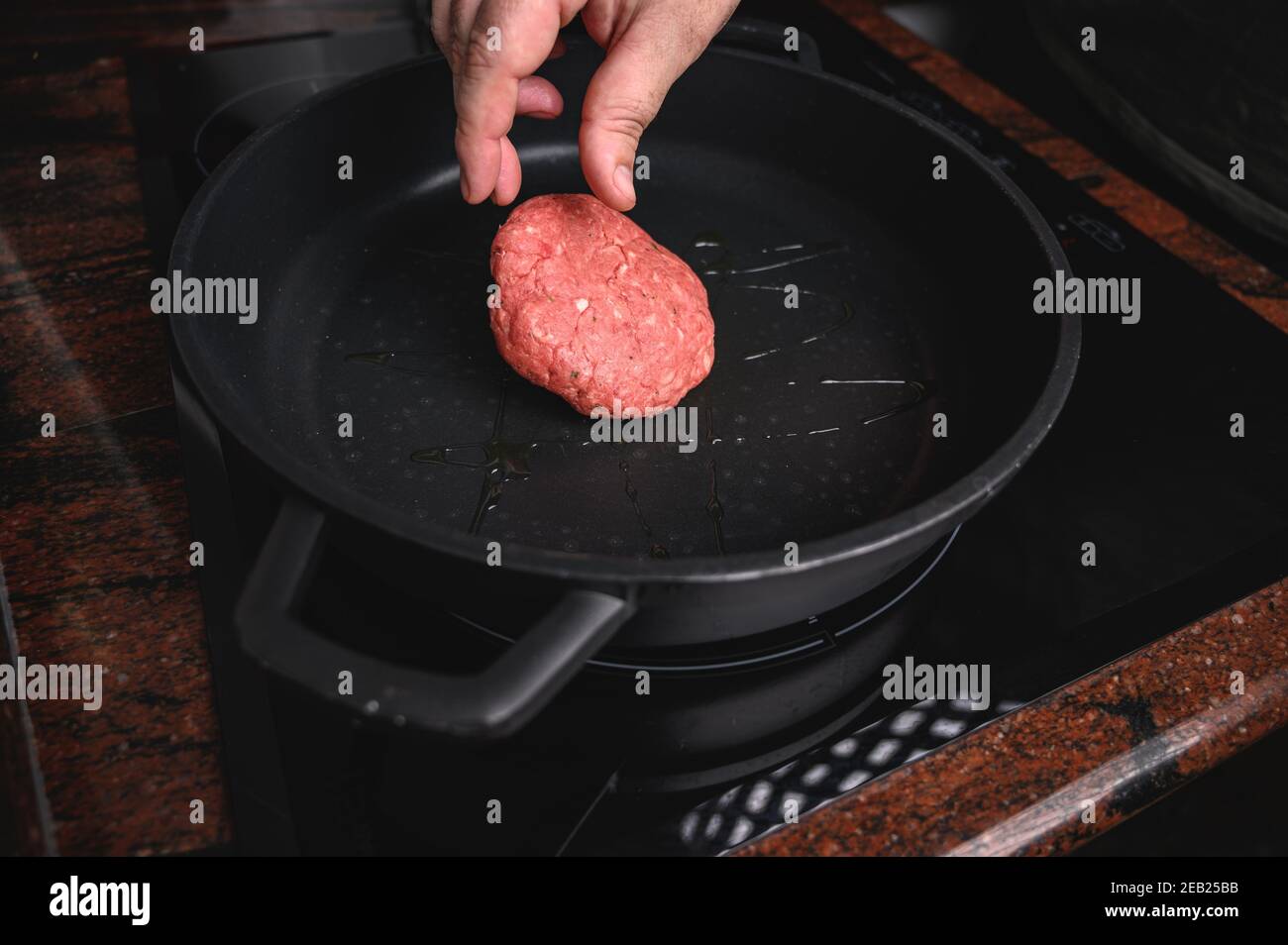 Closeup shot of a homemade hamburger cutlet frying in a pan Stock Photo ...