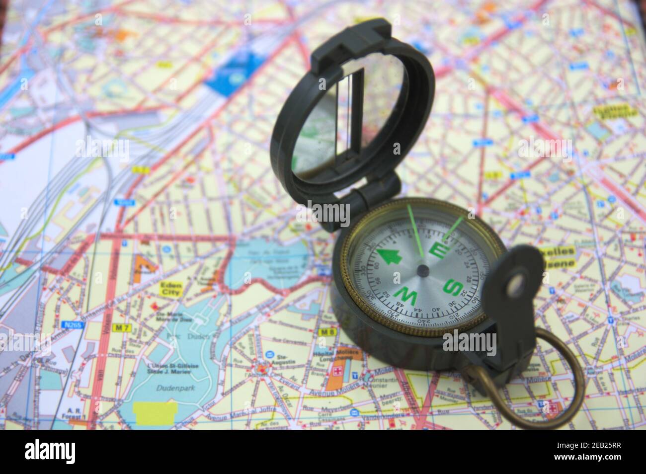 A paper map of a tourist city on which there is a magnetic compass with ...