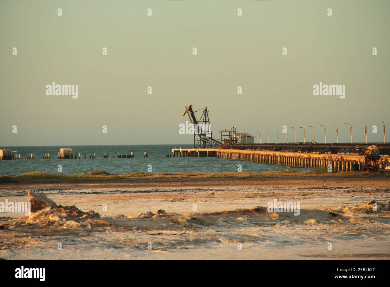 Beautiful view of a long jetty on a sandy coast Stock Photo - Alamy
