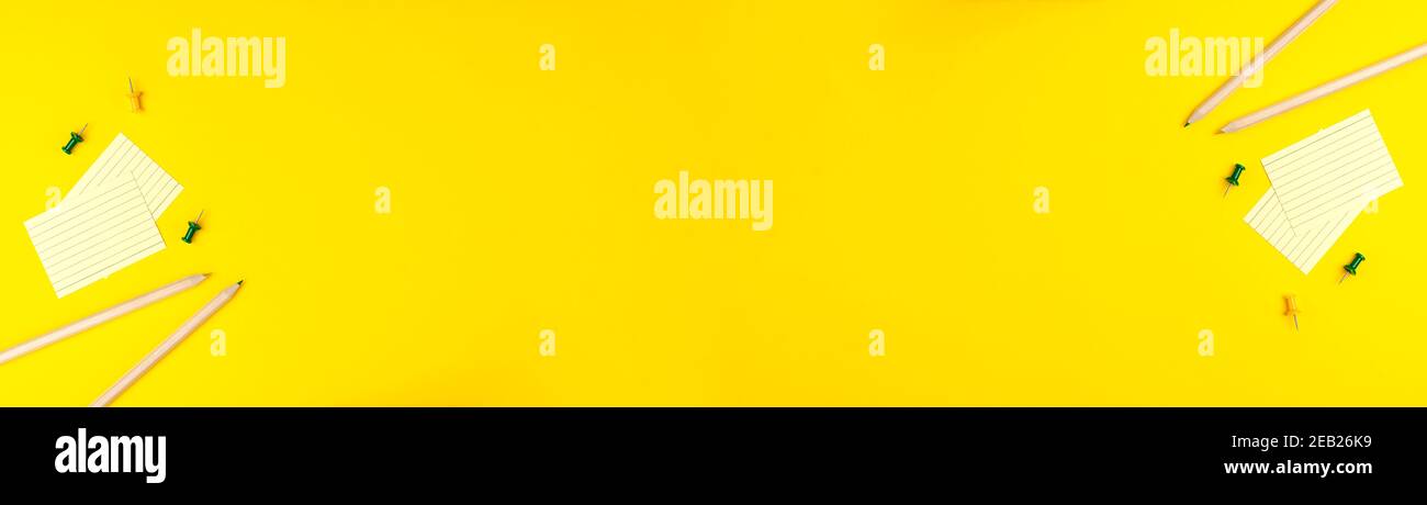 Banner of notepad, push pins, paper clip pencils on yellow background ...