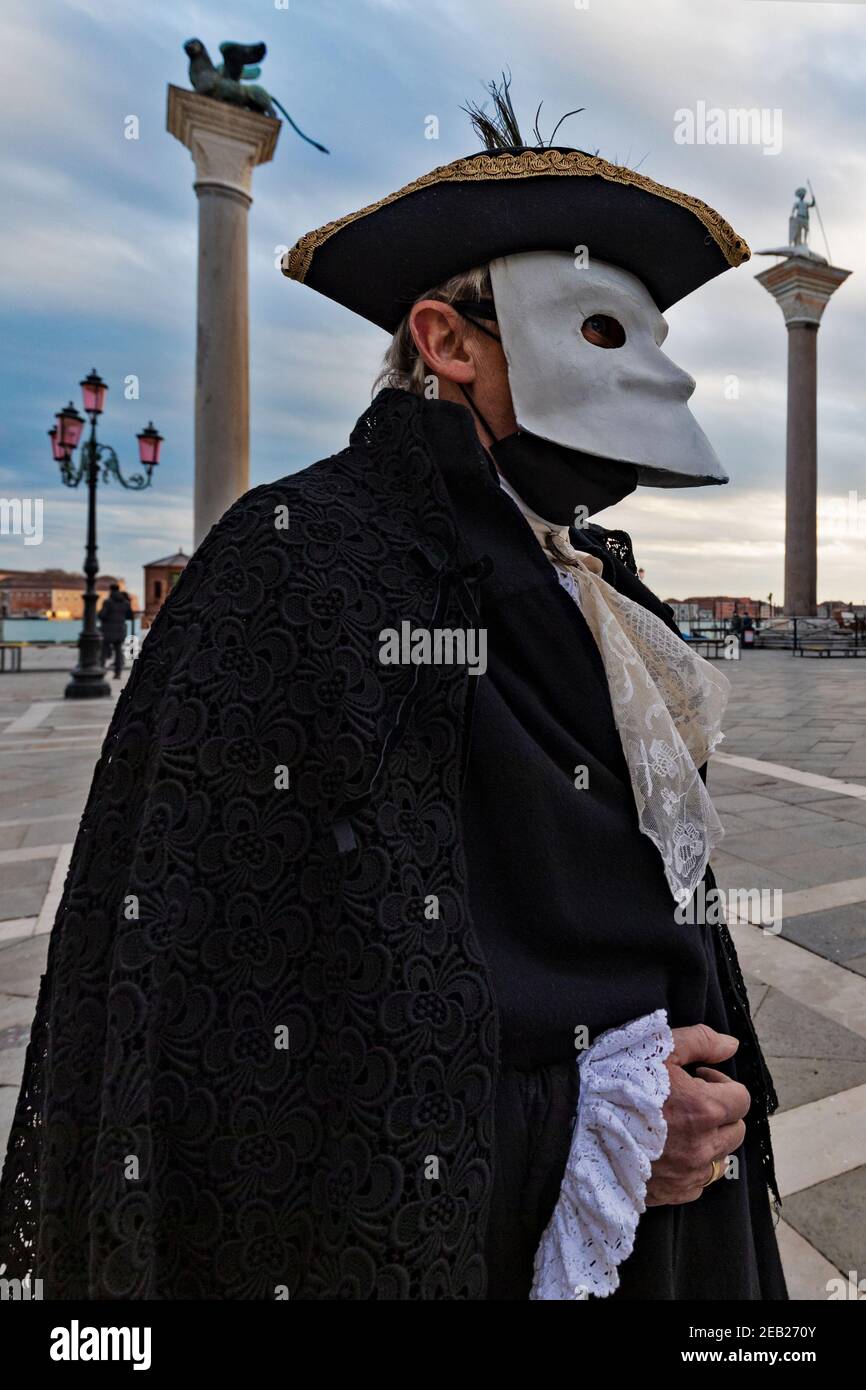 Traditional Bauta costume with cape, feathered tricornered hat and ...