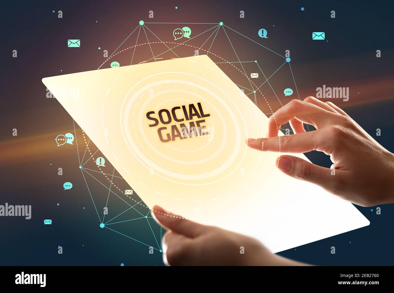 Holding futuristic tablet with SOCIAL GAME inscription, social media ...
