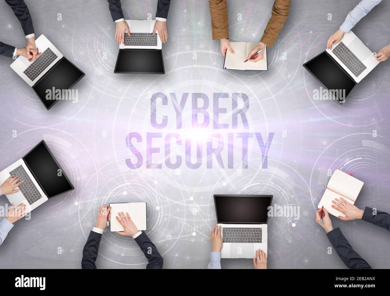Group of people in front of a laptop with CYBER SECURITY insciption ...