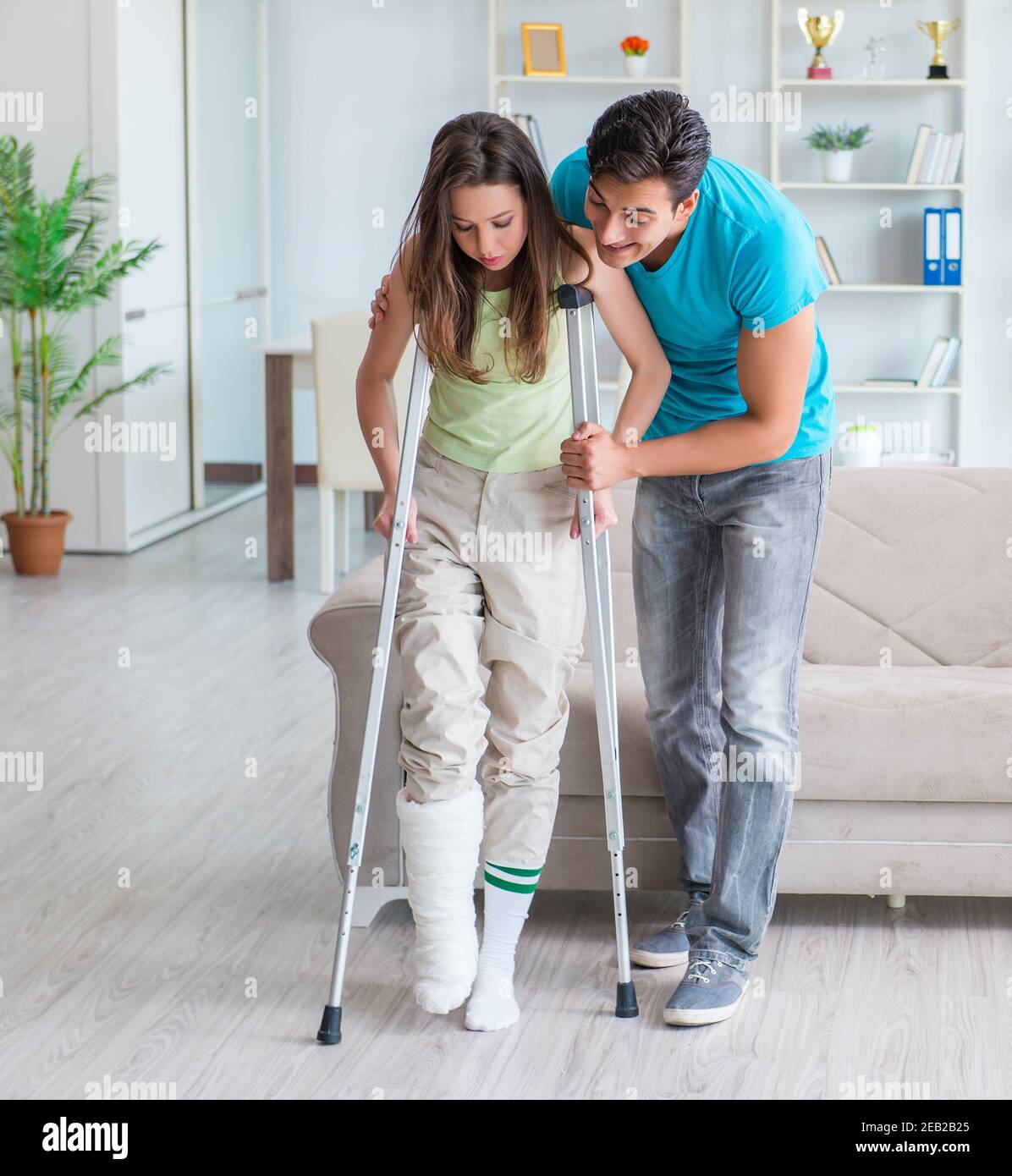The husband man supporting injured wife Stock Photo - Alamy