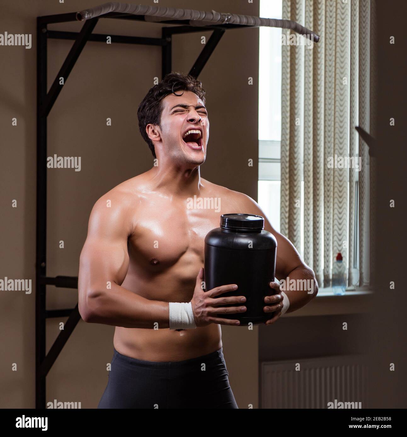 The man with nutrient supplements in sports gym Stock Photo - Alamy