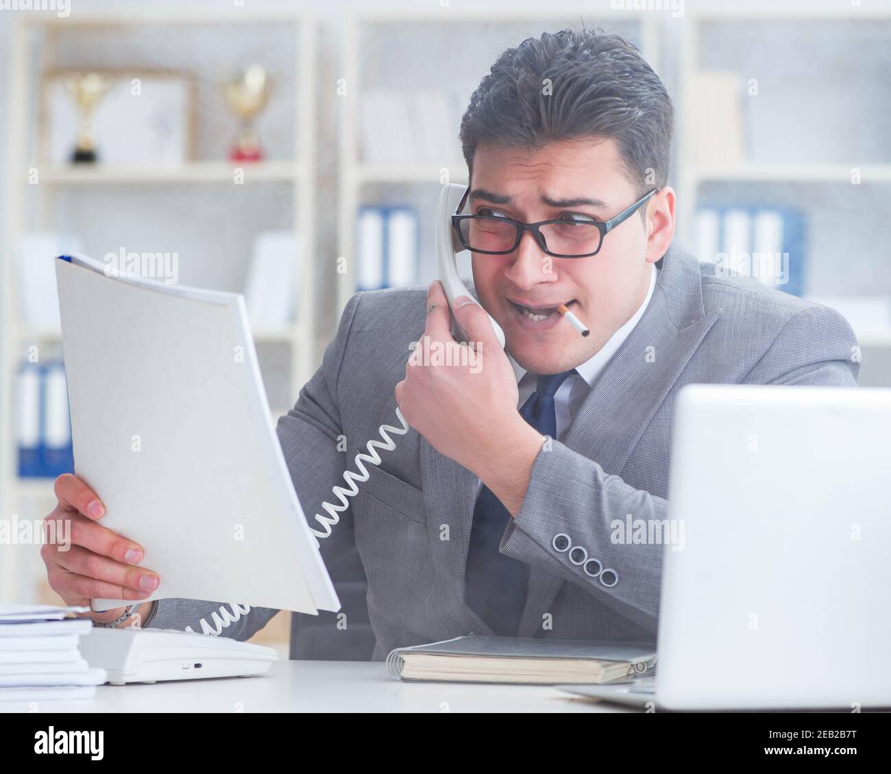 The businessman smoking in office at work Stock Photo - Alamy