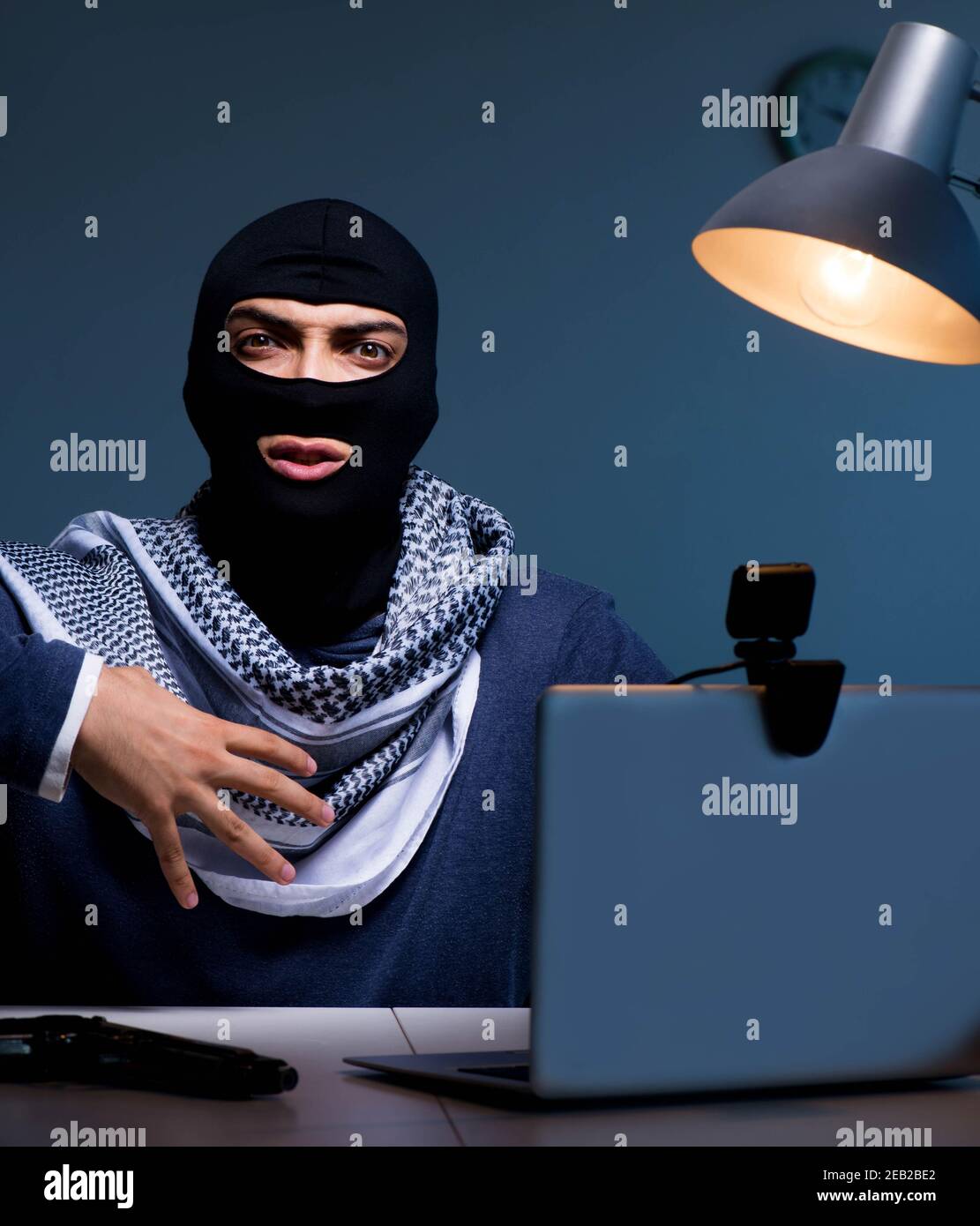 The hacker wearing balaclava mask hacking computer Stock Photo - Alamy