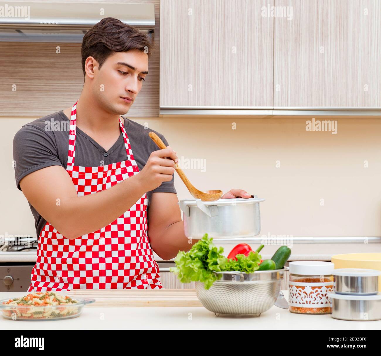 The man male cook preparing food in kitchen Stock Photo - Alamy