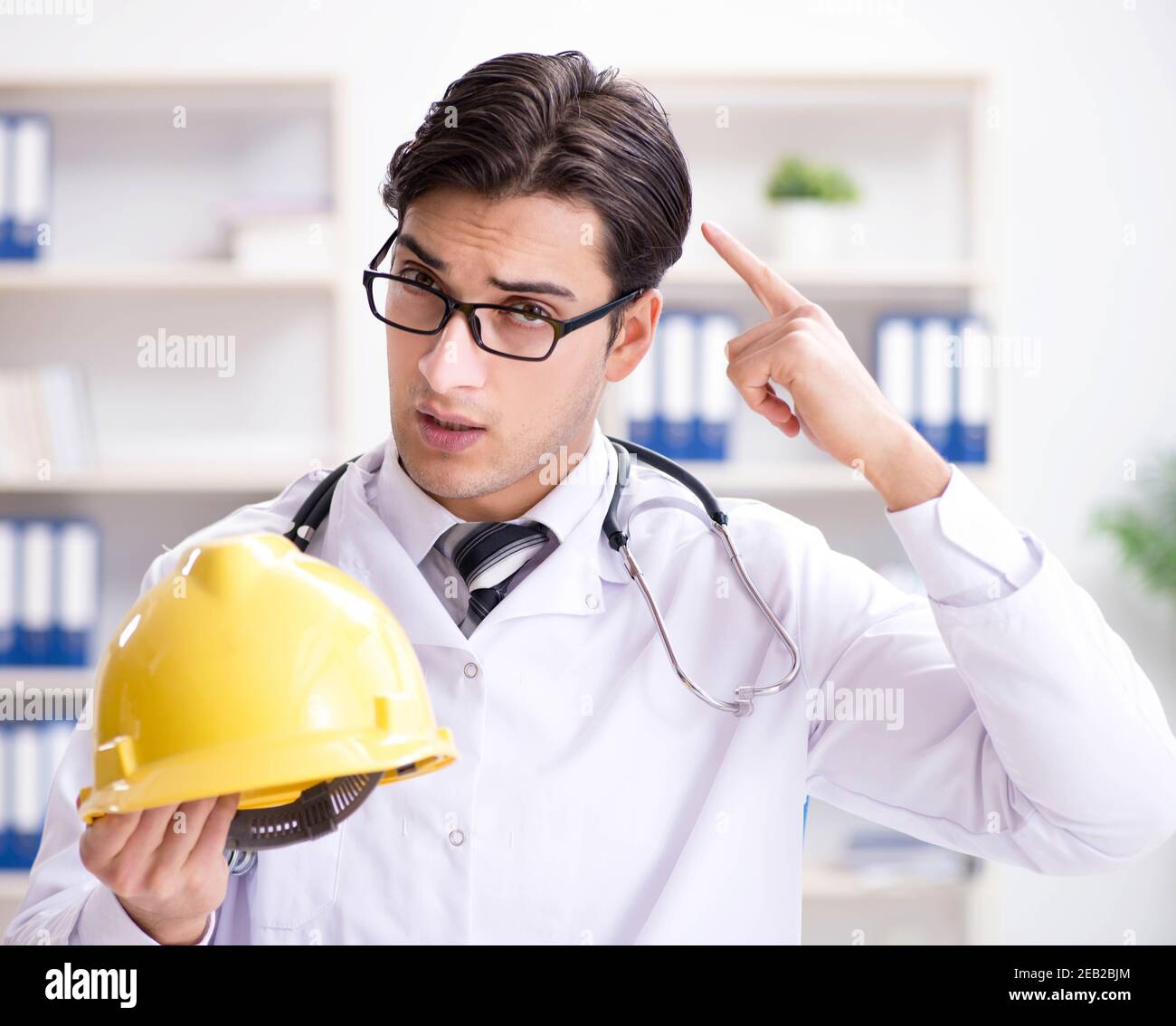 The safety doctor advising about wearing hard hat Stock Photo - Alamy