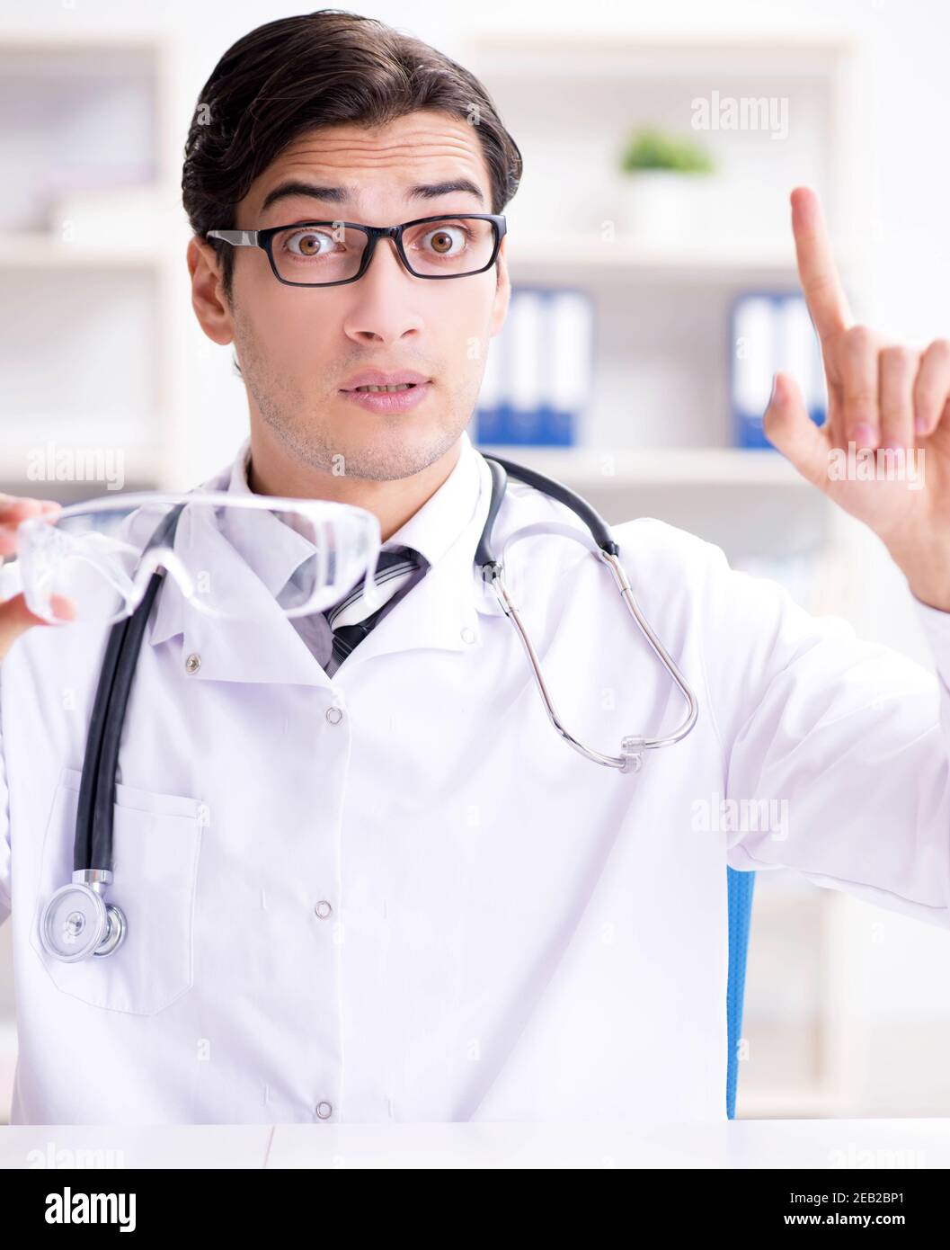 The safety doctor advising about wearing protective goggles Stock Photo ...