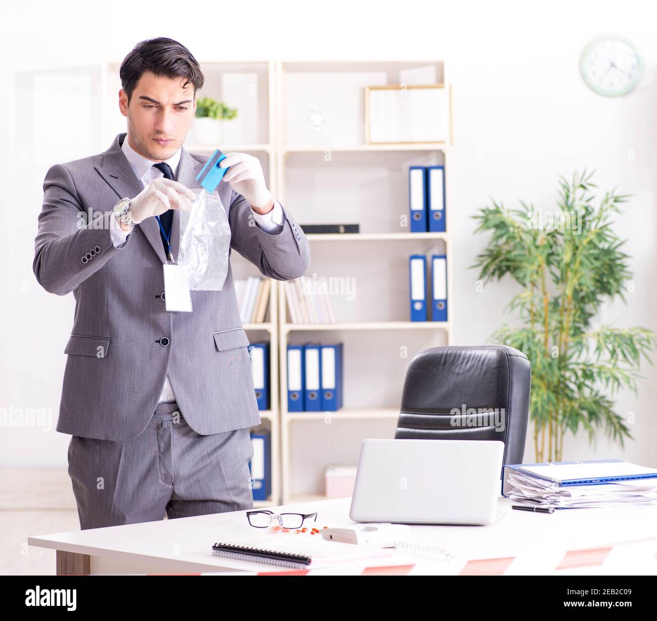 The forensics investigator at the scene of office crime Stock Photo - Alamy