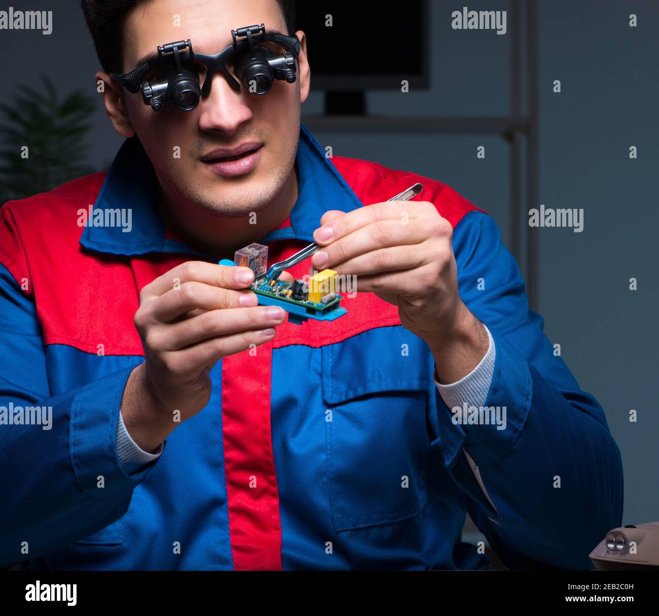 The computer specialist repairing pc late at night Stock Photo - Alamy