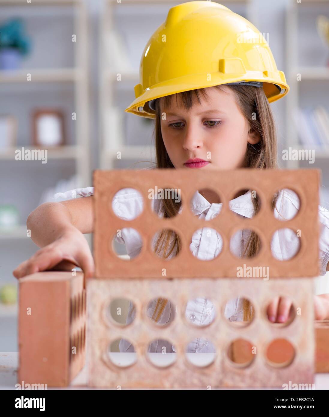 The young girl building with construction bricks Stock Photo - Alamy