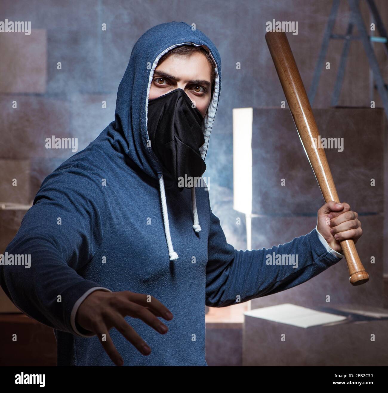 The hooligan with bat in dark room Stock Photo - Alamy