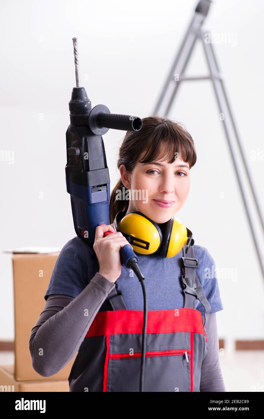 The woman contractor with hand drill at construction site Stock Photo ...