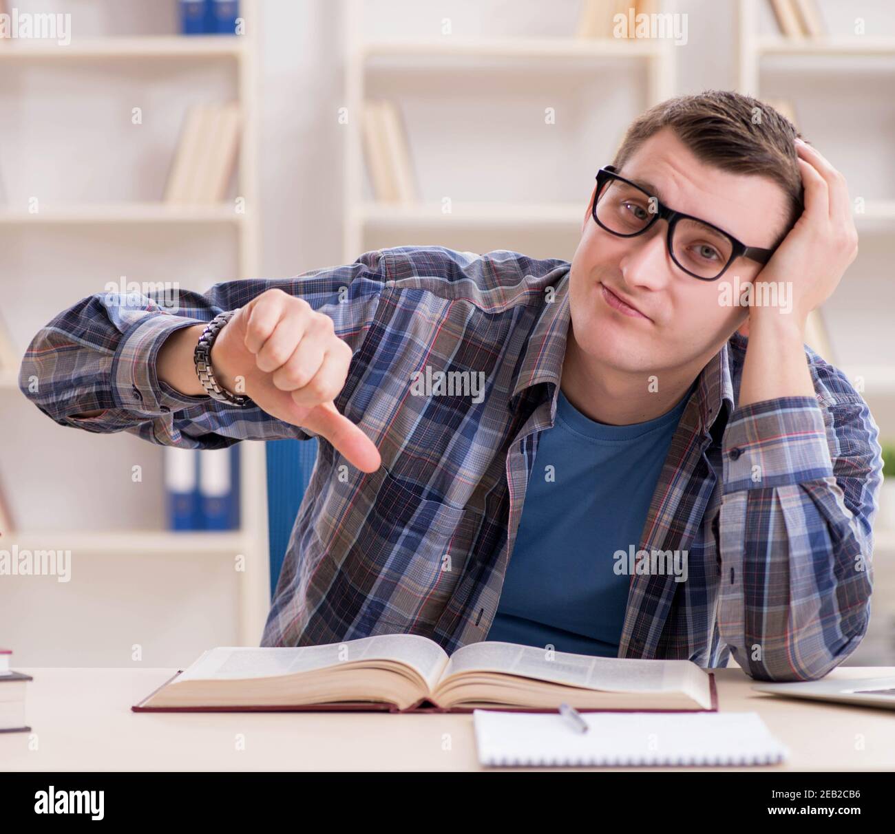 The young student preparing to school exams with books Stock Photo - Alamy