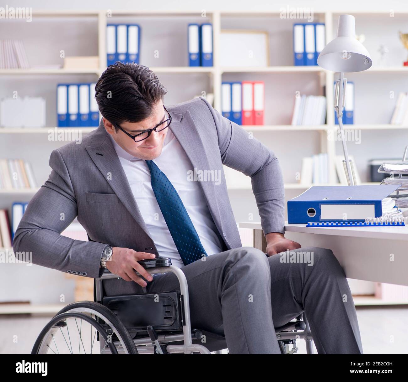 The disabled businessman working in the office Stock Photo - Alamy