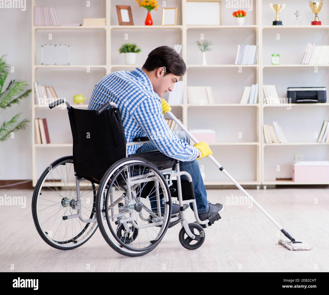 The disabled man on wheelchair cleaning home Stock Photo - Alamy
