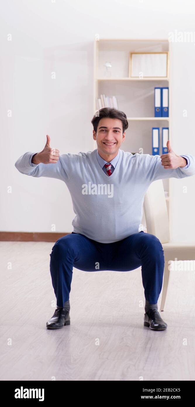 The employee doing stretching exercises in the office Stock Photo - Alamy