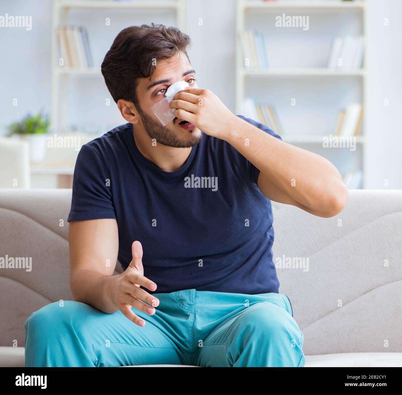 Young man recovering healing at home after plastic surgery nose job ...