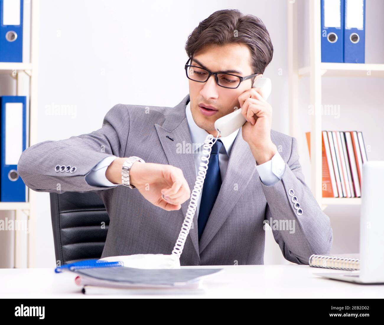 The businessman employee talking on the office phone Stock Photo - Alamy
