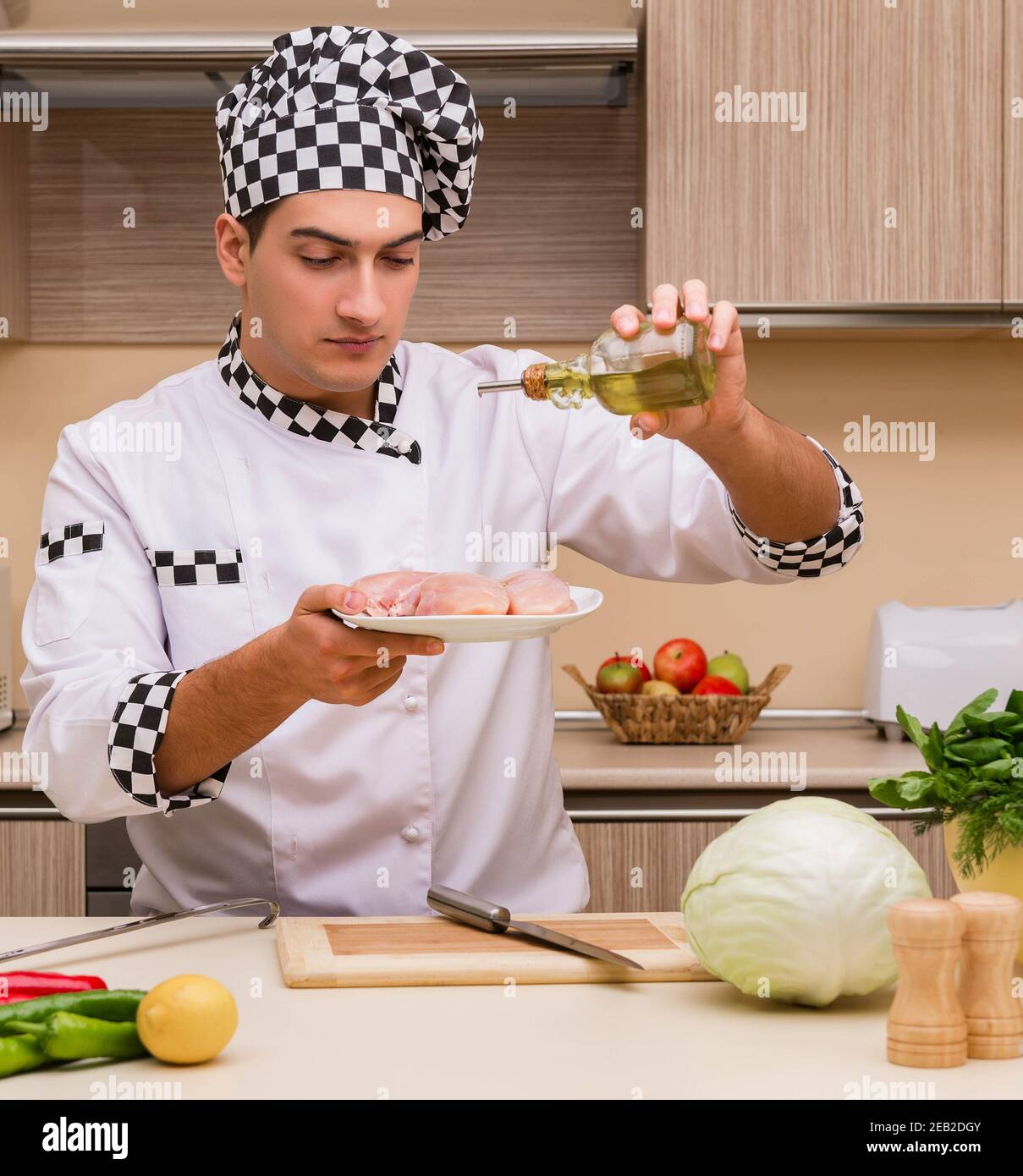 The young chef working in the kitchen Stock Photo - Alamy
