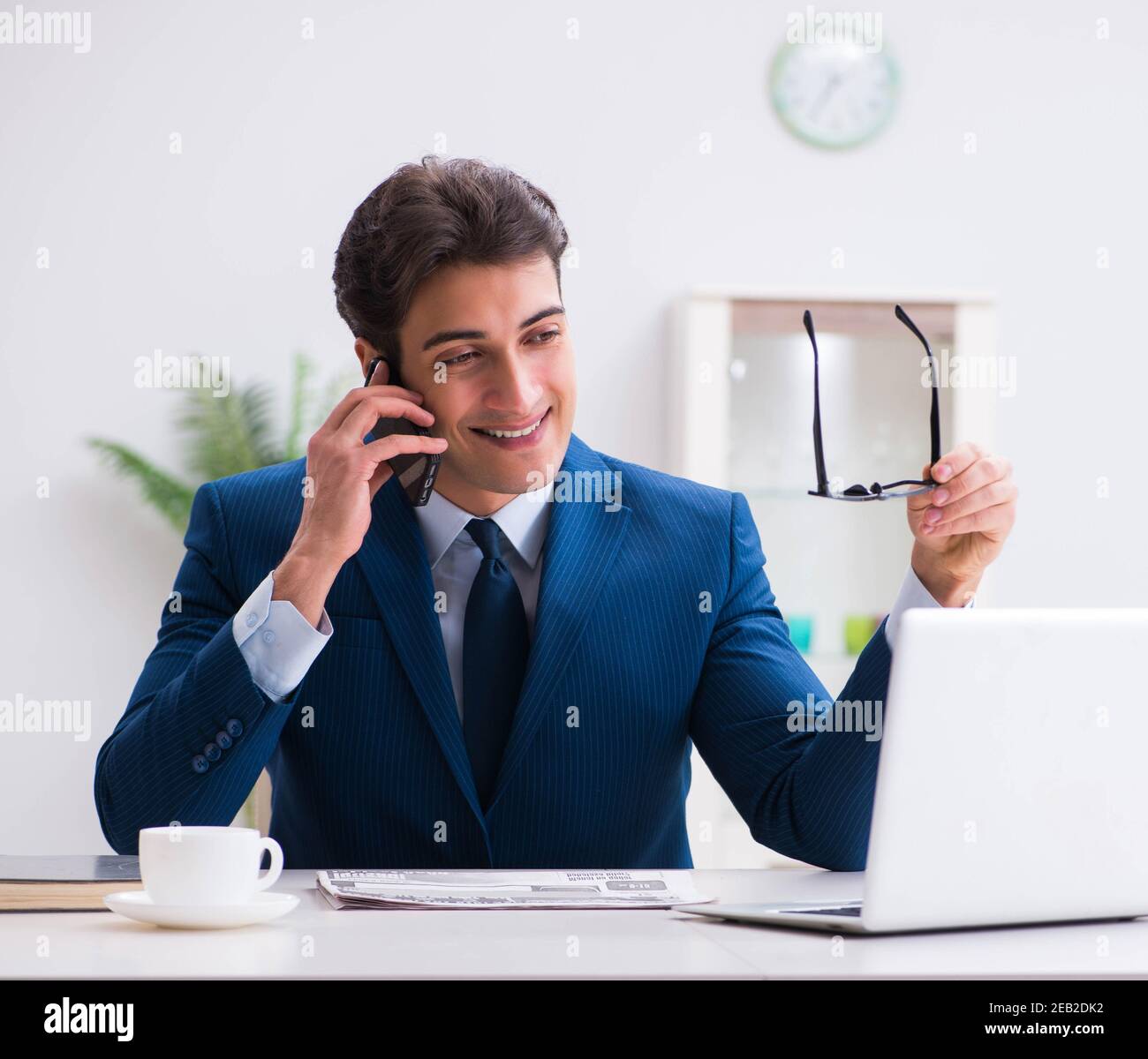 The businessman employee talking on the office phone Stock Photo - Alamy