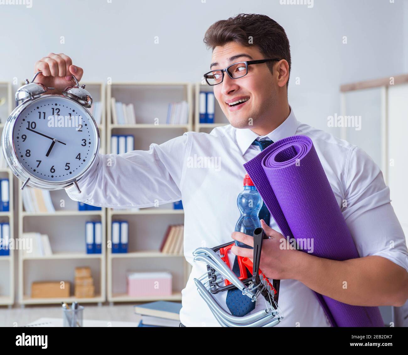 The businessman rushing to sports with clock Stock Photo - Alamy