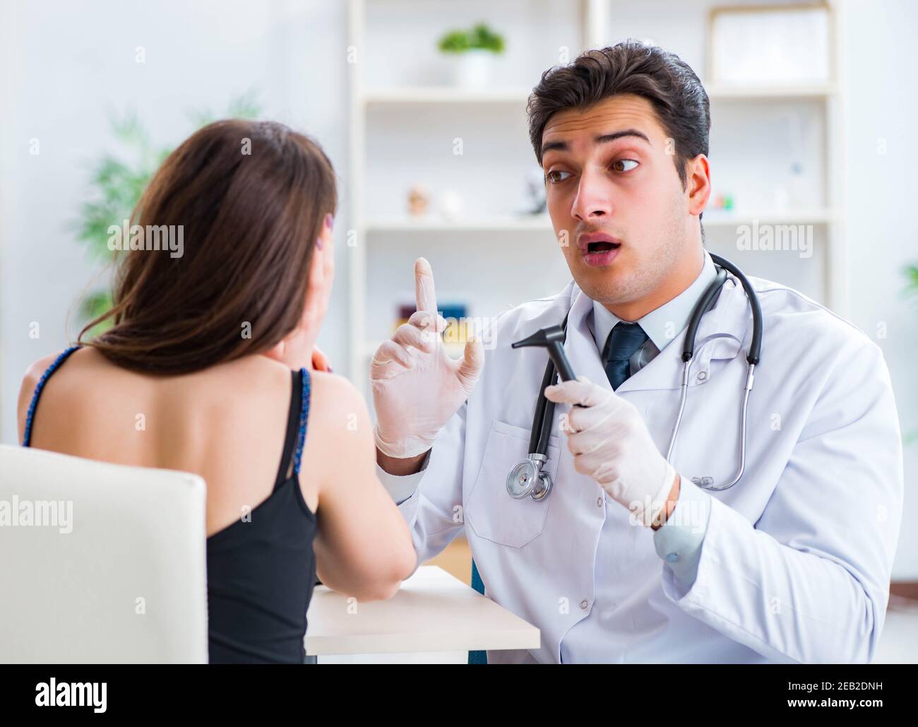 The doctor checking patients ear during medical examination Stock Photo ...