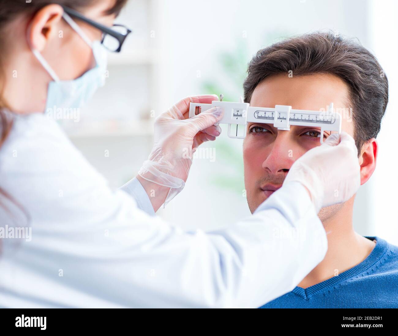 The ophthalmologist is checking up patient in eye doctor hospital Stock ...