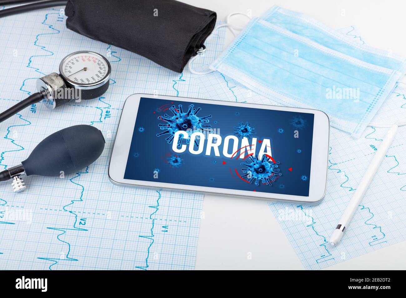 Tablet pc and doctor tools on white surface with CORONA inscription ...