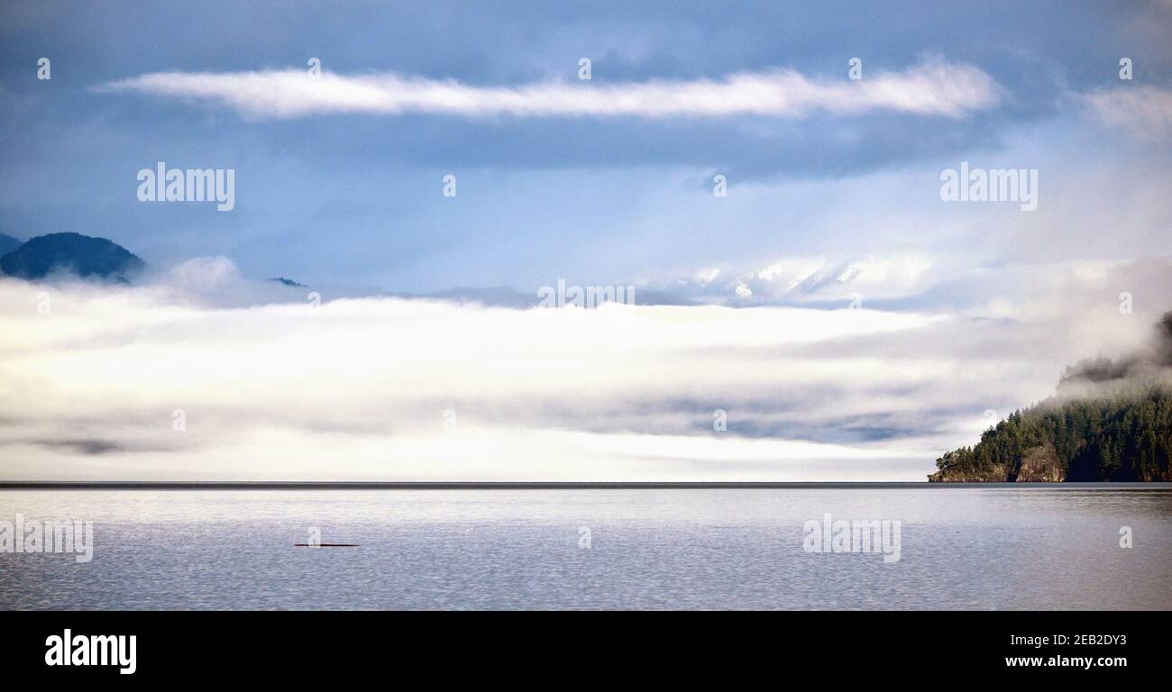 Morning Fog and Low Clouds Over Mountain Lake Stock Photo - Alamy