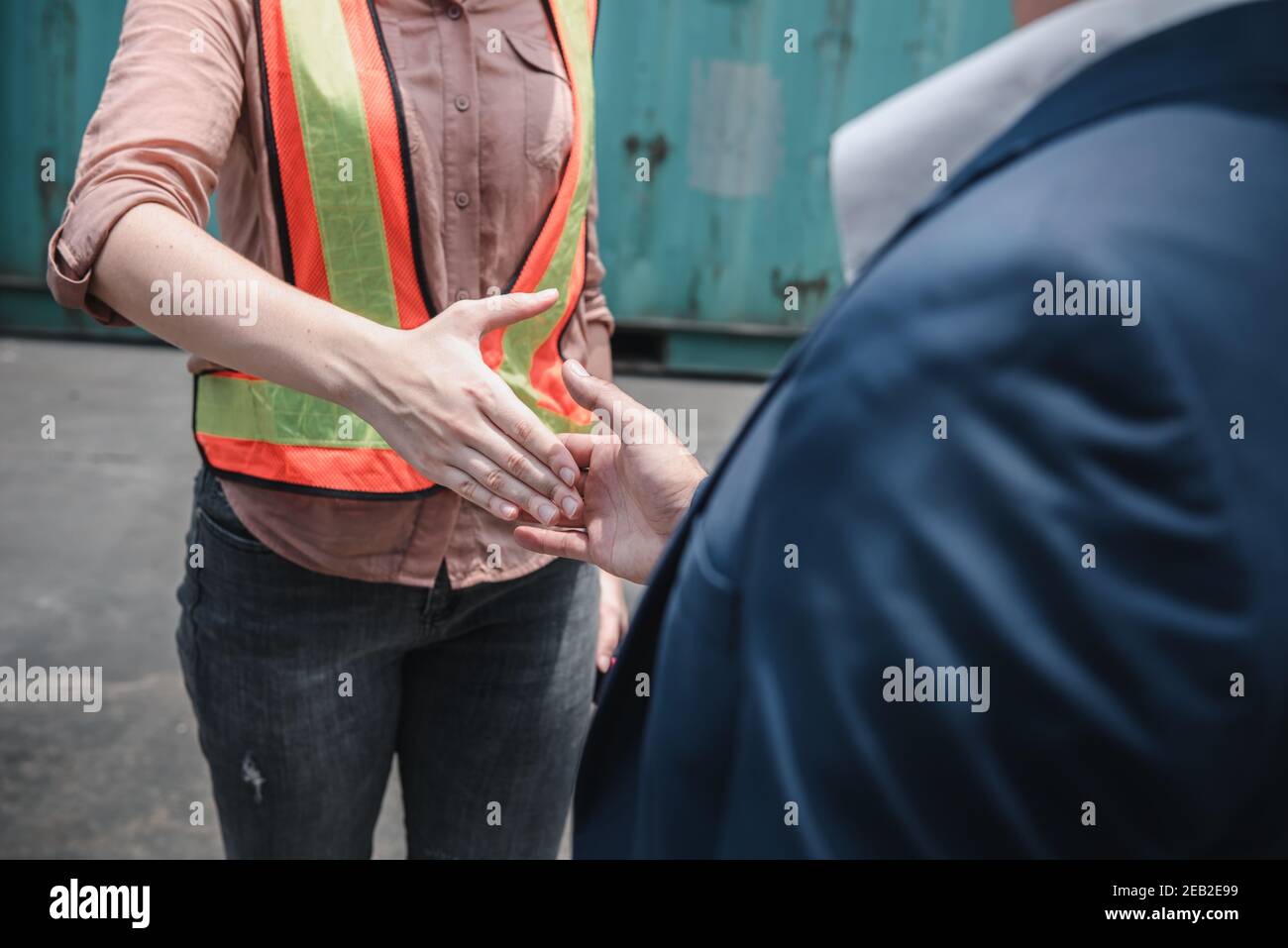 Businessman and Container Shipping Worker Handshake Together for ...