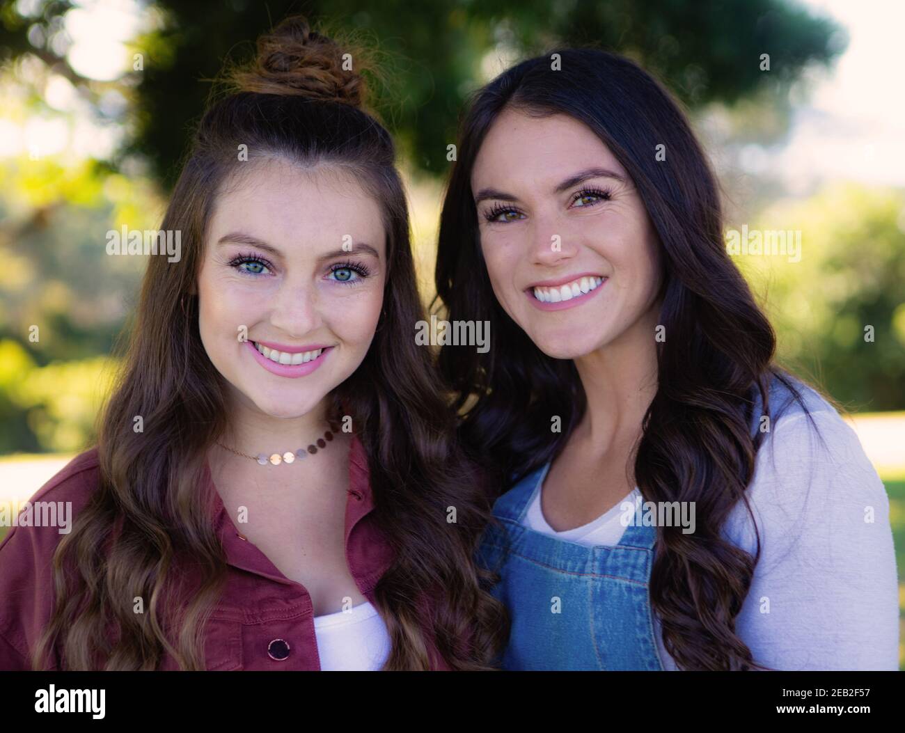 two sisters outdoors at a park Stock Photo - Alamy