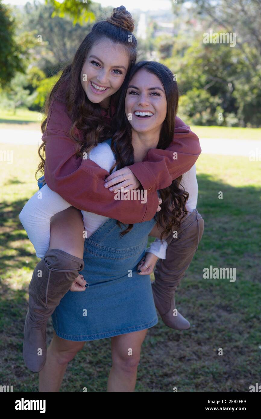 two sisters outdoors at a park Stock Photo - Alamy