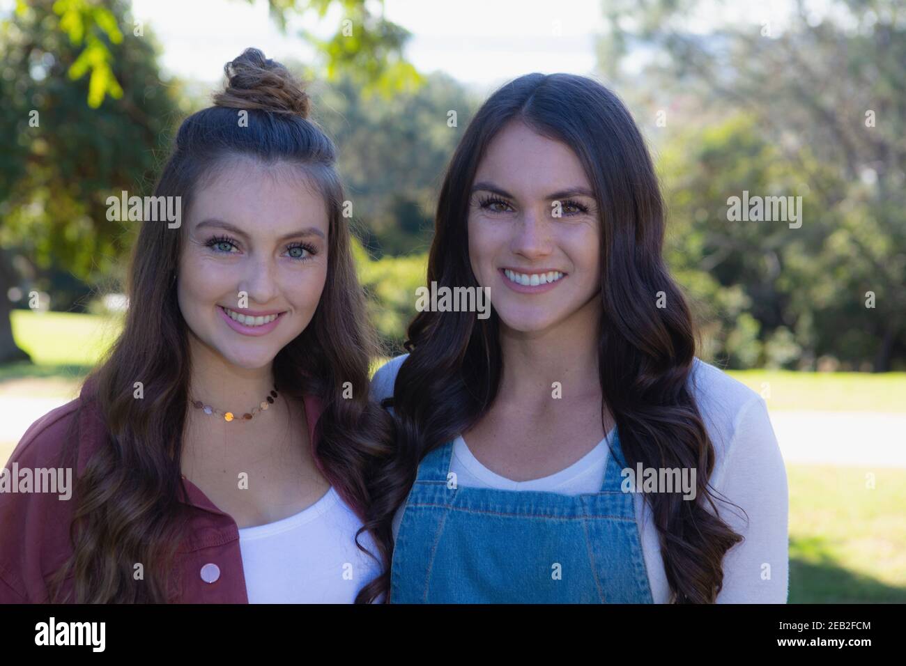 two sisters outdoors at a park Stock Photo - Alamy