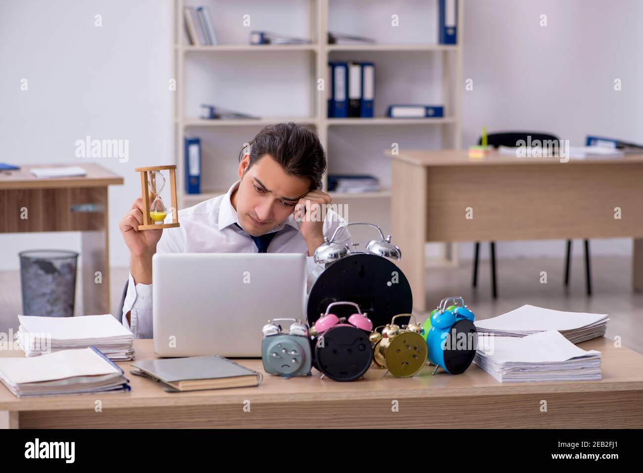 Young employee afraid of missing deadline at workplace Stock Photo - Alamy