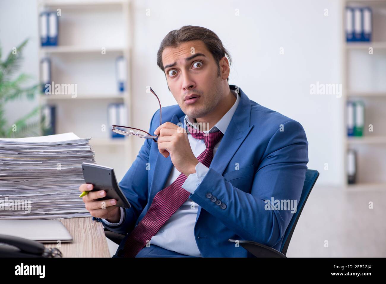 Sad tired male bookkeeper hi-res stock photography and images - Alamy