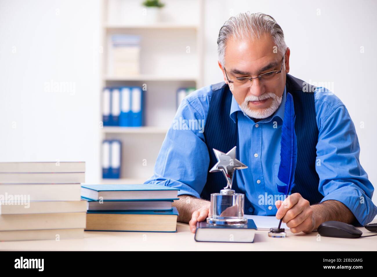 Old male author winning the award Stock Photo - Alamy