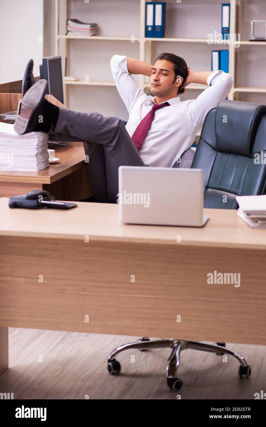 Young employee extremely tired with excessive work Stock Photo - Alamy
