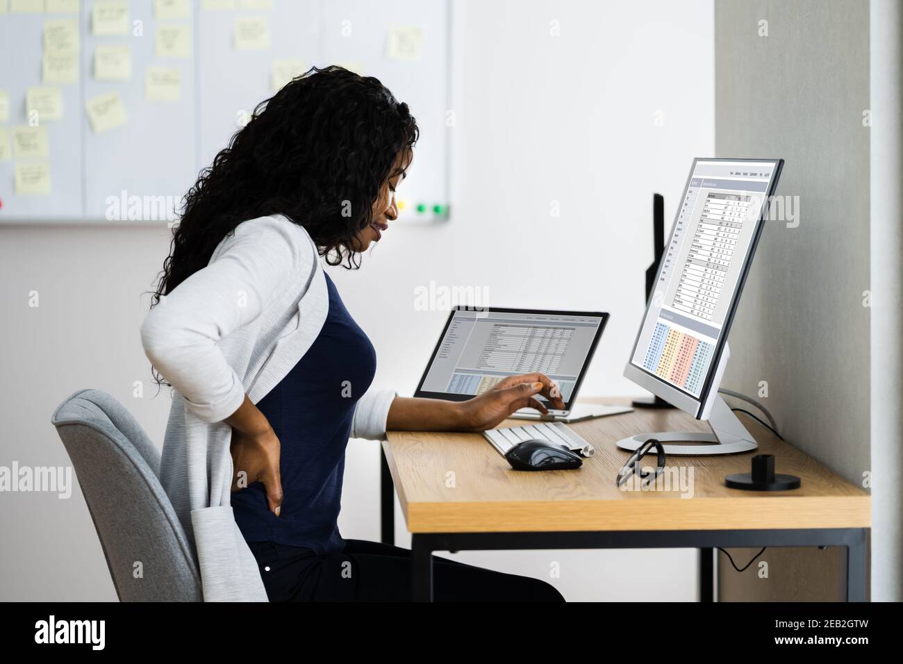 African Back Pain At Work Desk. Posture Problem Stock Photo - Alamy