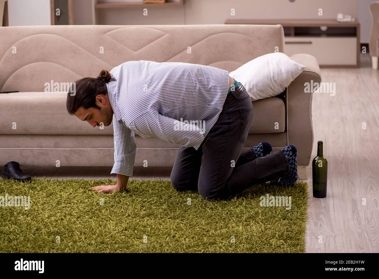 Young drunken man suffering at home Stock Photo - Alamy