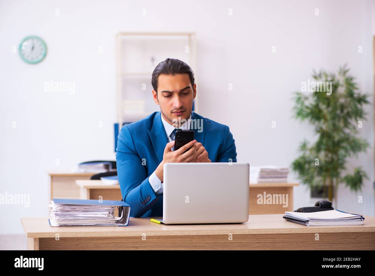Young employee and too many work in the office Stock Photo - Alamy