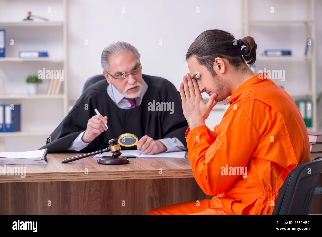 Old judge meeting with young captive in courthouse Stock Photo - Alamy