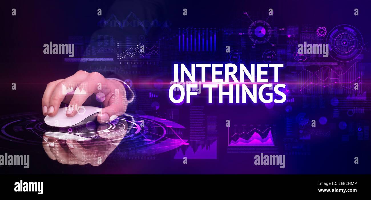 hand holding wireless peripheral with INTERNET OF THINGS inscription ...