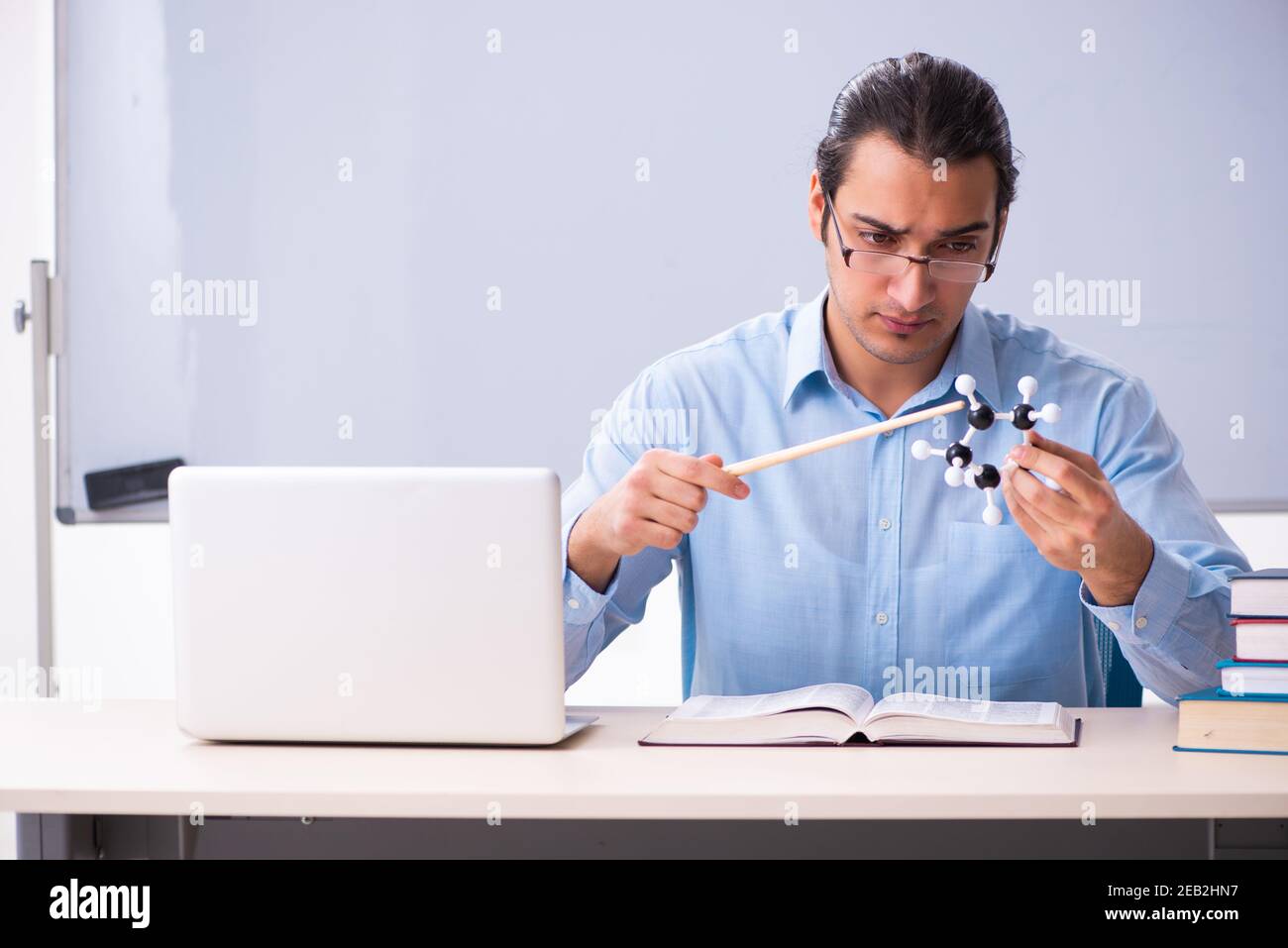 Young physics teacher in front of whiteboard Stock Photo - Alamy