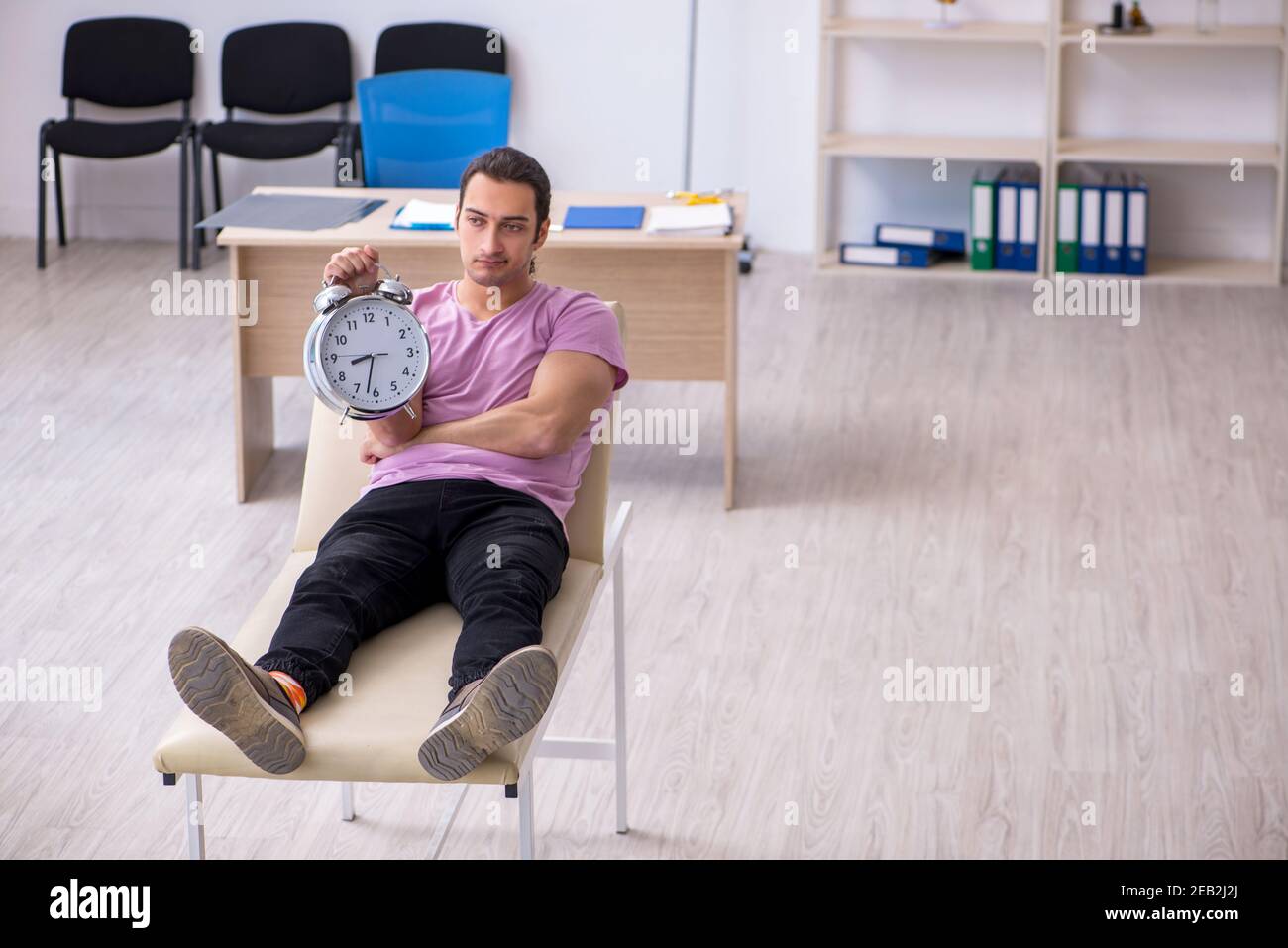 Male patient waiting for doctor in time management concept Stock Photo ...